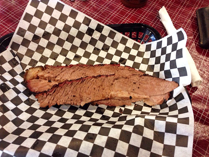 Behold the holy grail of BBQ—brisket with that perfect pink smoke ring that whispers sweet nothings about its long, slow dance with hardwood smoke.