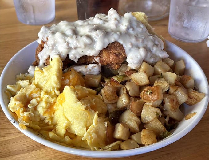 Behold the holy trinity of Southern breakfast: creamy gravy cascading over golden chicken, fluffy eggs, and potatoes crisped to perfection.