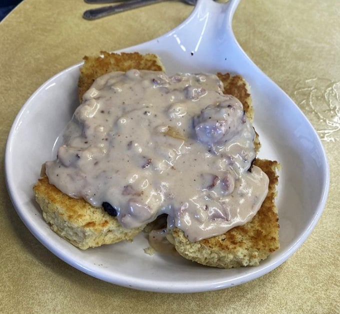Behold the holy grail of comfort food: golden biscuits baptized in peppery sausage gravy that would make your grandmother simultaneously proud and jealous.