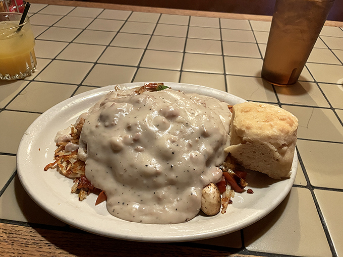 Behold the holy trinity of breakfast perfection: golden hash browns, a cloud-like biscuit, and gravy so good you'll want to write poetry about it. Speckled with pepper and studded with sausage, this is gravy with gravitas.