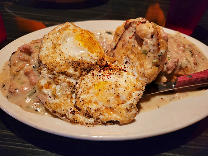 Behold the holy grail of breakfast: towering biscuits smothered in sausage-studded gravy with eggs that could make a rooster jealous.