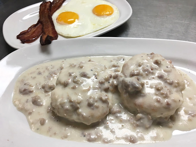 Behold the crown jewel: biscuits swimming in peppery sausage gravy alongside perfectly fried eggs and bacon &ndash; a breakfast trinity that inspires religious devotion.