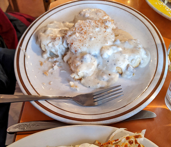 Biscuits and gravy so good they should require a permission slip. That pepper-flecked gravy is practically begging for a spoon... or a straw.