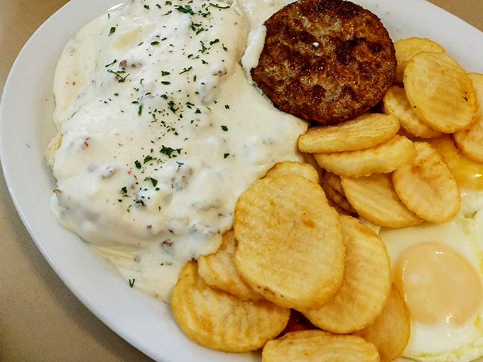 Behold the star attraction: biscuits smothered in creamy, peppery gravy alongside golden home fries and a perfect egg.