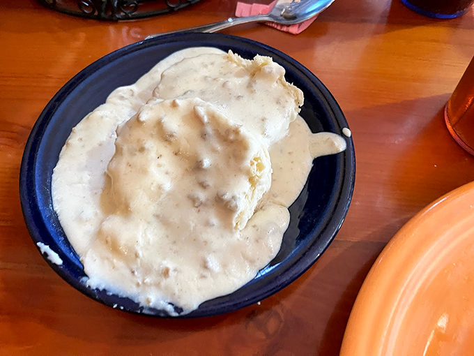 Behold the star attraction&mdash;a cloud-like biscuit swimming in peppery sausage gravy. This isn't just breakfast; it's edible therapy.