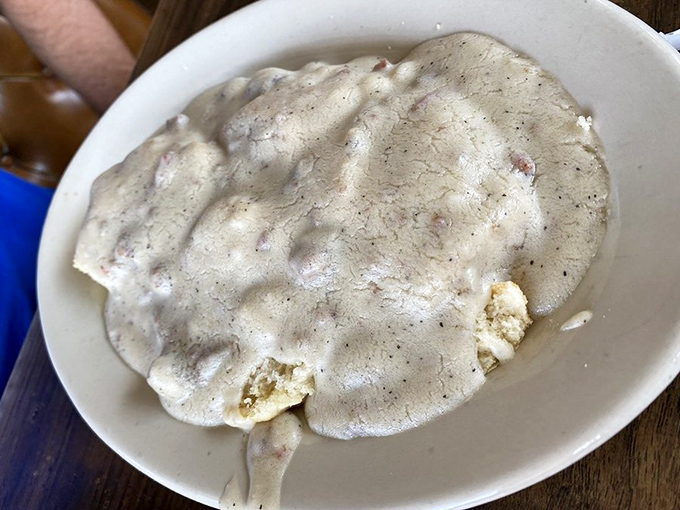 Behold the star attraction: biscuits drowning in a sea of peppery sausage gravy. This isn't a side dish – it's the main event.