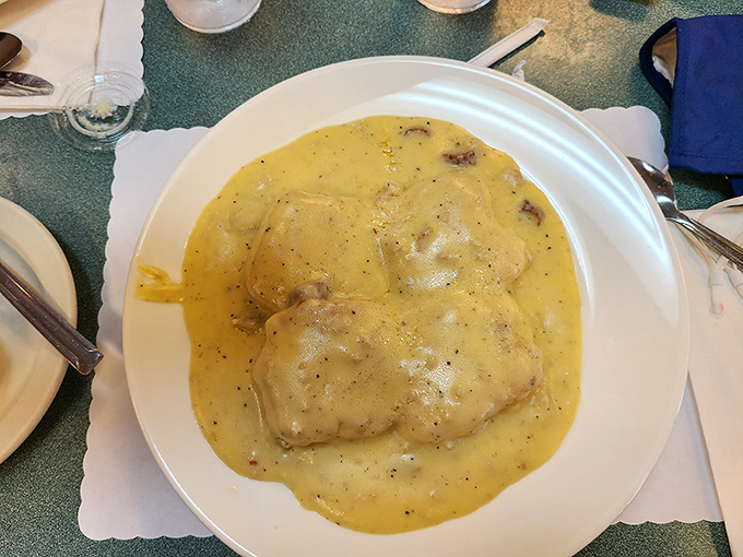 Behold the star attraction: biscuits swimming in peppery sausage gravy. This plate has launched a thousand food pilgrimages and zero regrets.