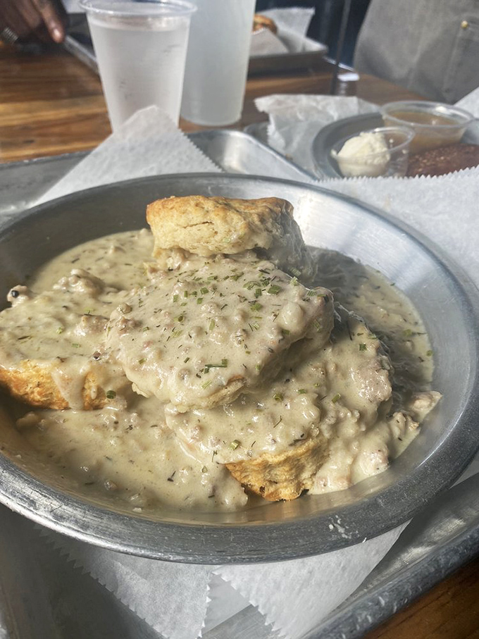 Behold the star attraction: biscuits swimming in creamy thyme sausage gravy. This isn't just breakfast; it's a religious experience with herbs.