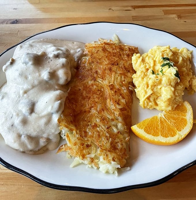 Crispy hash browns, creamy gravy, and perfectly scrambled eggs &ndash; the holy trinity of breakfast perfection arranged on a plate like edible artwork.