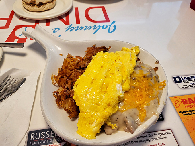 Breakfast alchemy at its finest &ndash; a golden omelet spills over crispy hash browns with a side of gravy that would make your grandmother jealous.