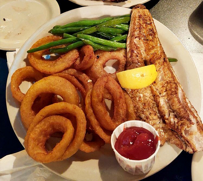 The star of the show: blackened walleye with crispy onion rings and vibrant green beans&mdash;a plate of pure Ohio joy.