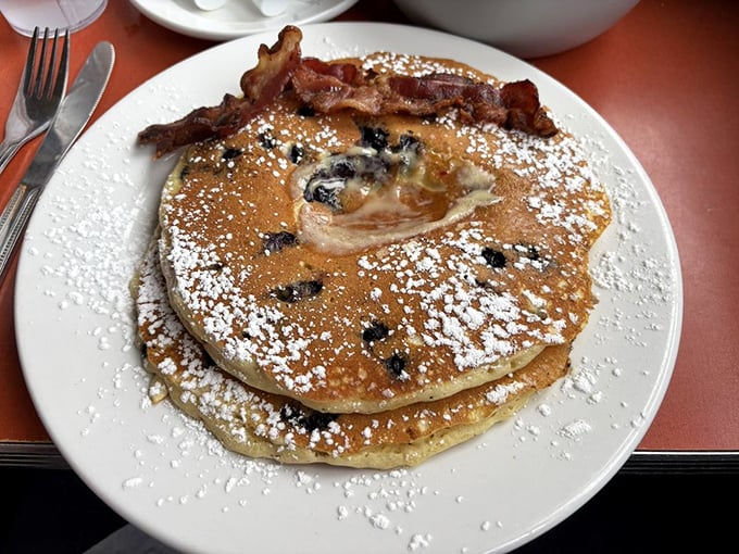 These aren't just pancakes&mdash;they're fluffy discs of joy with blueberries that pop like flavor fireworks in your mouth. Worth setting the alarm for.