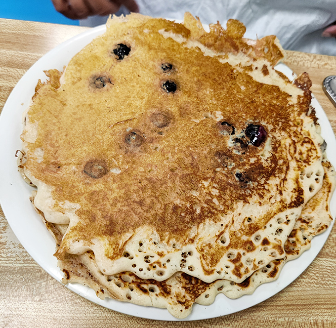 These blueberry pancakes aren't just breakfast&mdash;they're edible art with crispy edges and pockets of warm berries that burst like tiny flavor bombs.