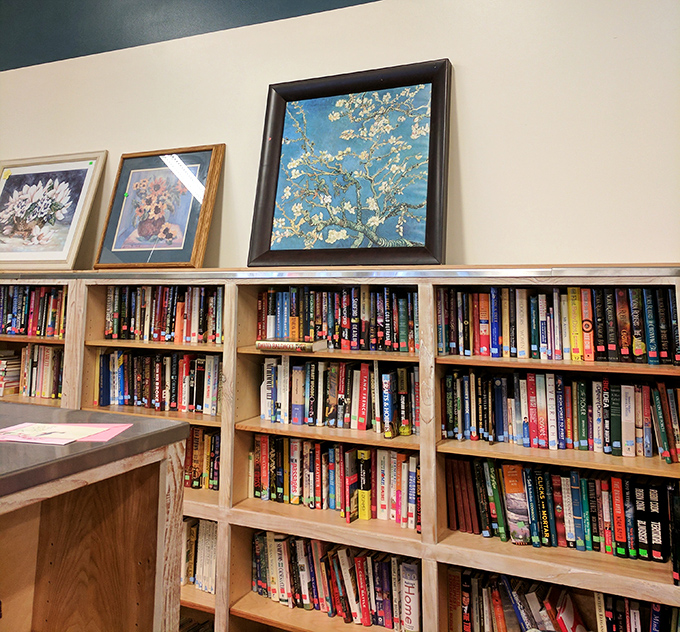 Literary treasures line these shelves, where bestsellers of yesteryear mingle with timeless classics. That Van Gogh print? Just a bonus visual feast.