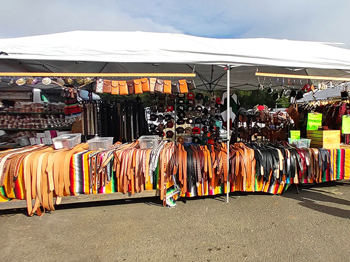 A leather lover's dream! These colorful belts hang like a desert sunset, each one waiting to hold up someone's pants with a touch of southwestern flair.