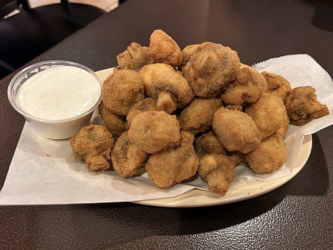 These aren't just breaded mushrooms; they're little golden orbs of happiness. Crispy exterior, juicy interior, and that ranch dipping sauce—it's the appetizer trifecta!