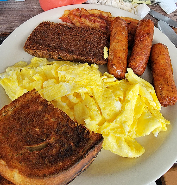 Breakfast perfection on a plate &ndash; scrapple, sausage links, and eggs scrambled just right, with toast that's actually worthy of the calories.