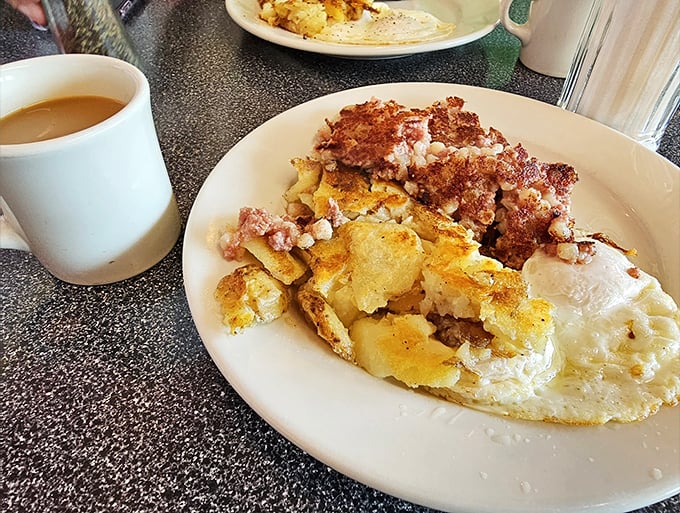 Behold the breakfast of champions: home fries crisped to perfection, eggs sunny-side up, and what appears to be ham&mdash;a holy trinity of morning delights.