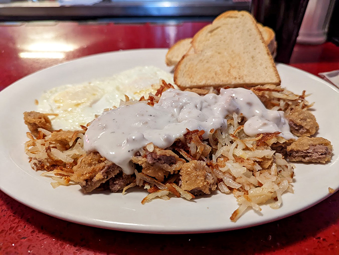 Behold the country breakfast in all its glory&mdash;crispy hash browns smothered in gravy, eggs sunny-side up, and toast standing by for yolk-sopping duty.