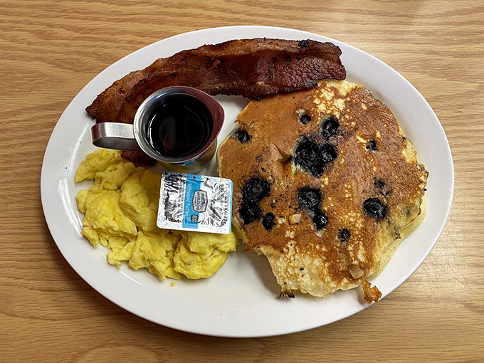 Blueberry pancakes that could make IHOP executives weep, served with eggs that practically glow and bacon that's achieved crispy-chewy perfection. 