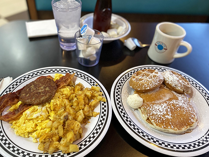This is what breakfast dreams are made of: golden pancakes dusted with powdered sugar alongside perfectly scrambled eggs, crispy bacon, and home fries.