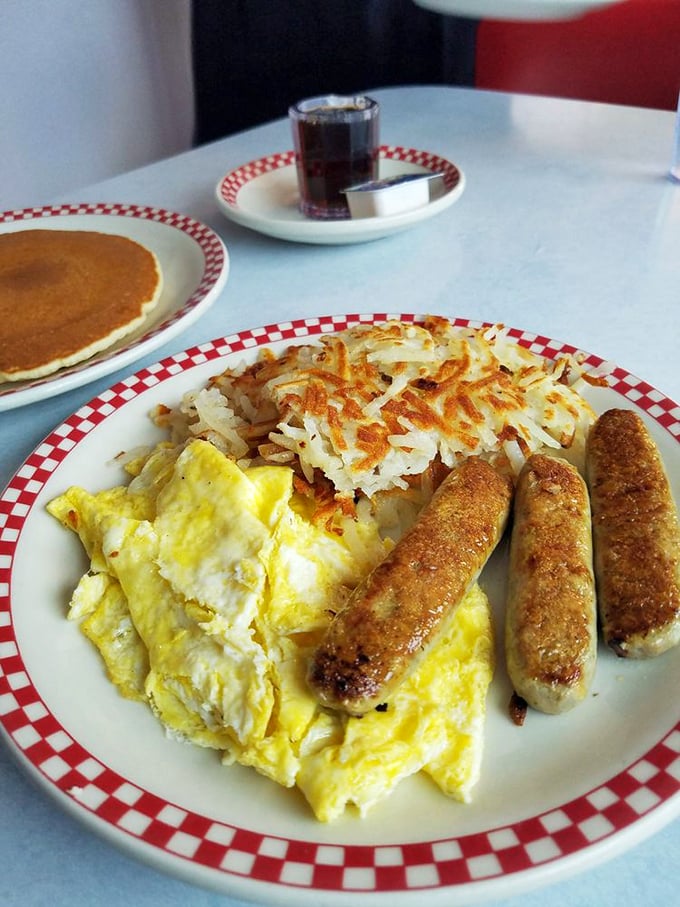 This isn't just breakfast—it's a morning symphony of perfectly cooked eggs, golden hash browns, and sausage links that snap with each bite.
