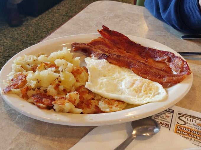 Behold the holy trinity of breakfast: perfectly crisped home fries, eggs with just-right yolks, and bacon that would make even vegetarians question their life choices.