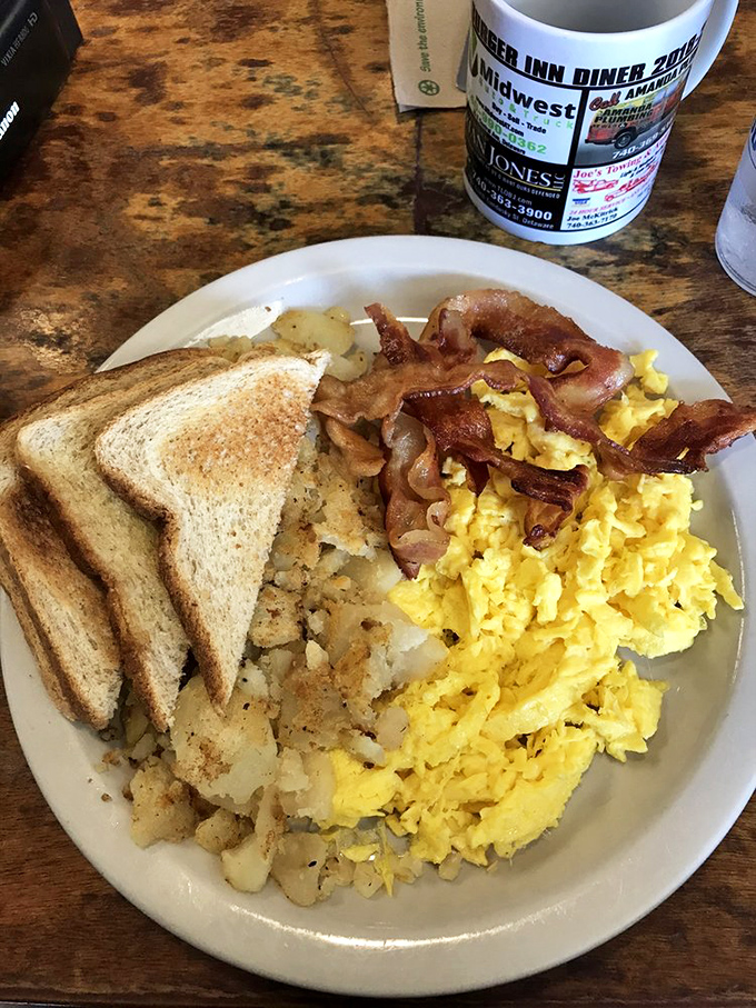 Breakfast nirvana achieved: golden hash browns, scrambled eggs that actually taste like eggs, bacon with the perfect crisp-to-chew ratio, and toast ready for action.