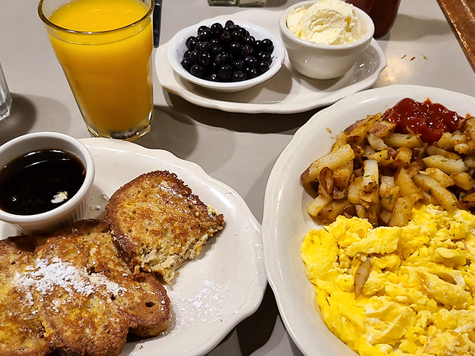 French toast that's had a proper education &ndash; crisp edges, custardy center, and fresh berries that didn't just fall off the truck yesterday.