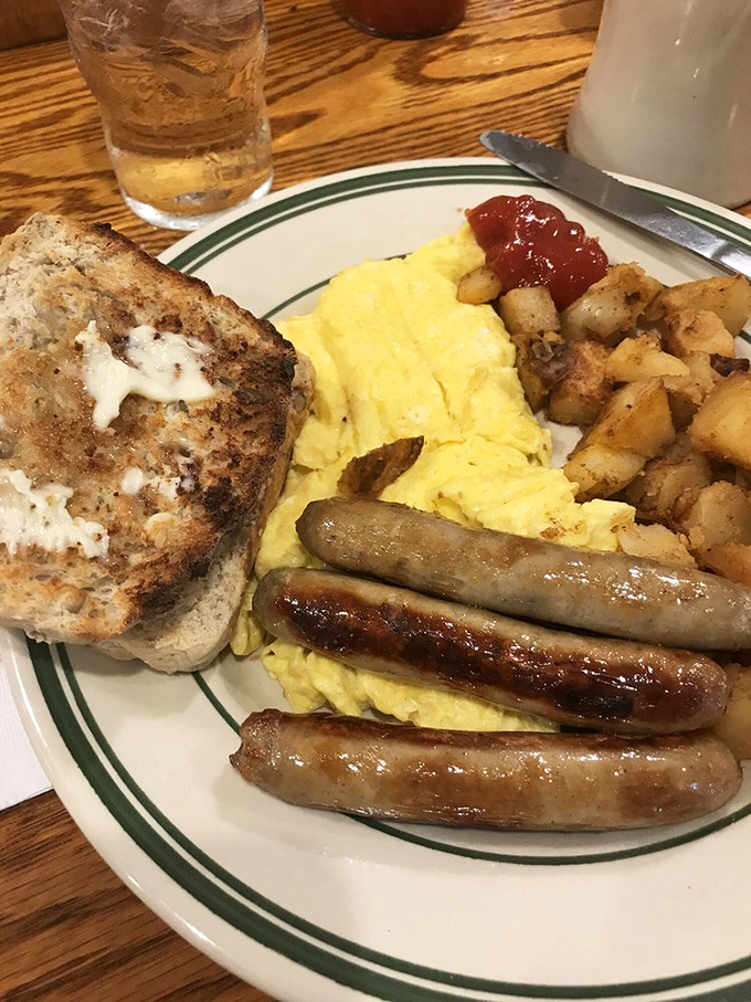 The breakfast trinity: perfectly scrambled eggs, sausage links with that satisfying snap, and home fries that justify getting out of bed.