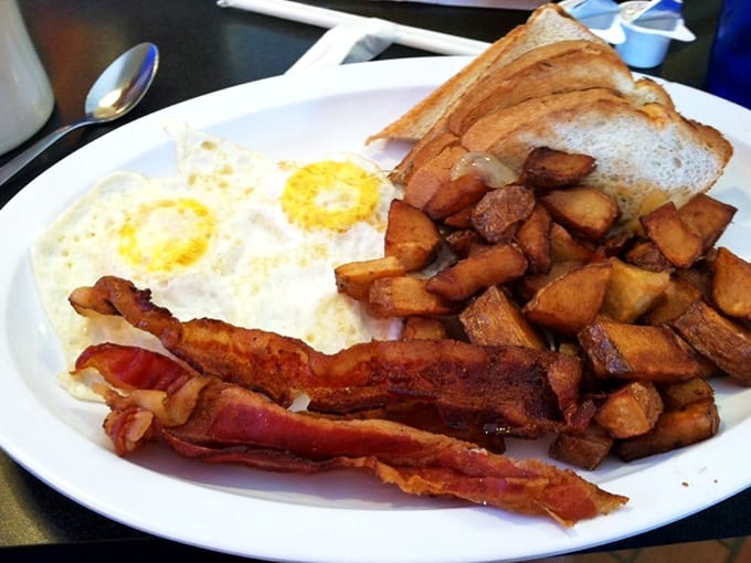 Two sunny-side up eggs flanked by crispy bacon and home fries&mdash;the breakfast trinity that's been solving life's problems since the invention of the griddle.