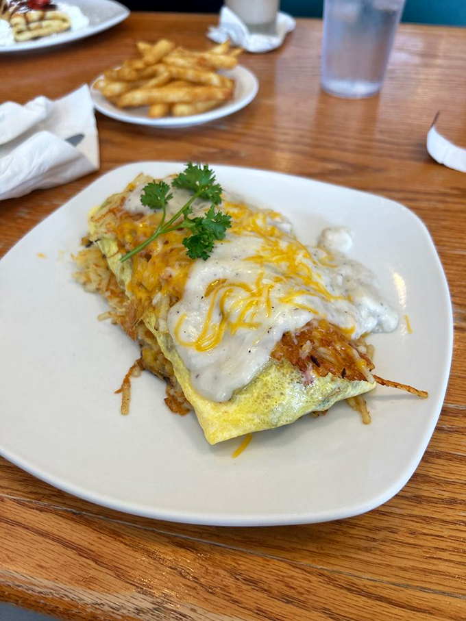 Breakfast lasagna that defies gravity and convention&mdash;layers of morning magic topped with cheese and gravy that would make your cardiologist wince and your soul sing.