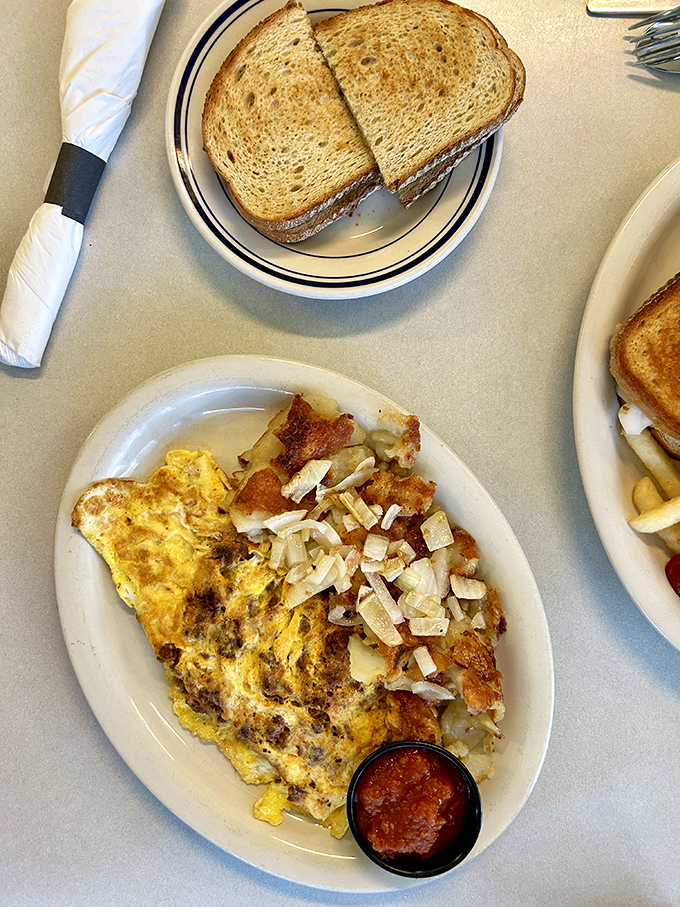 This Western omelet doesn't just satisfy hunger &ndash; it conquers it. Paired with perfectly crispy home fries and toast, it's the breakfast of champions.