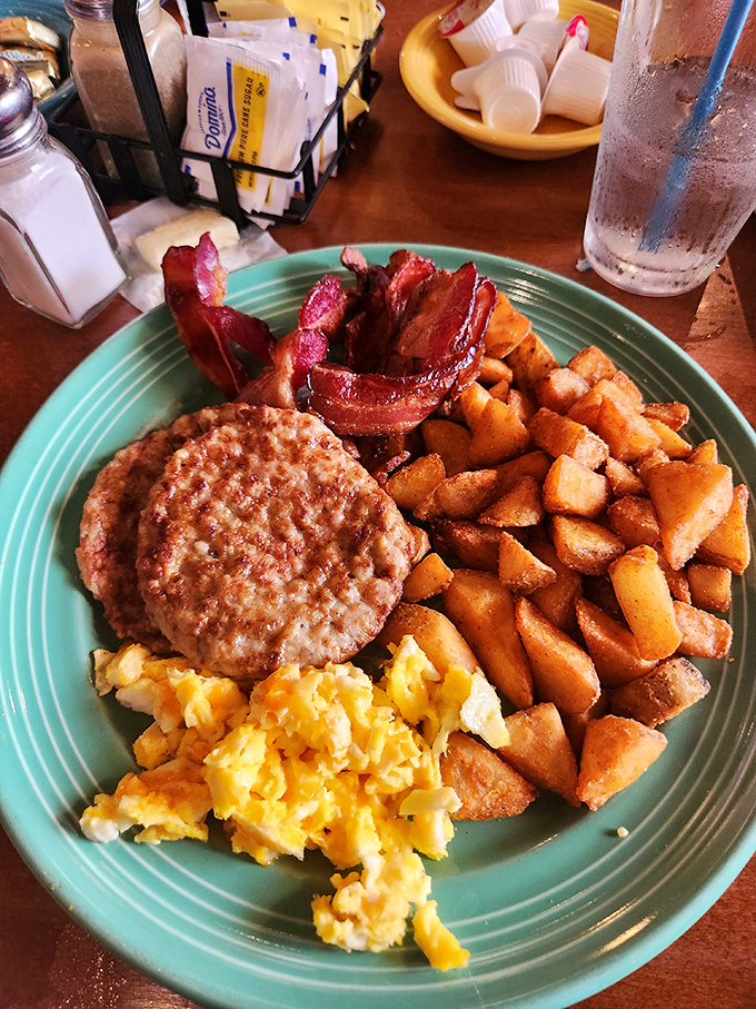 Crispy hash browns, perfectly cooked eggs, bacon, and sausage on one plate proves that sometimes the classics become classics for excellent reasons.
