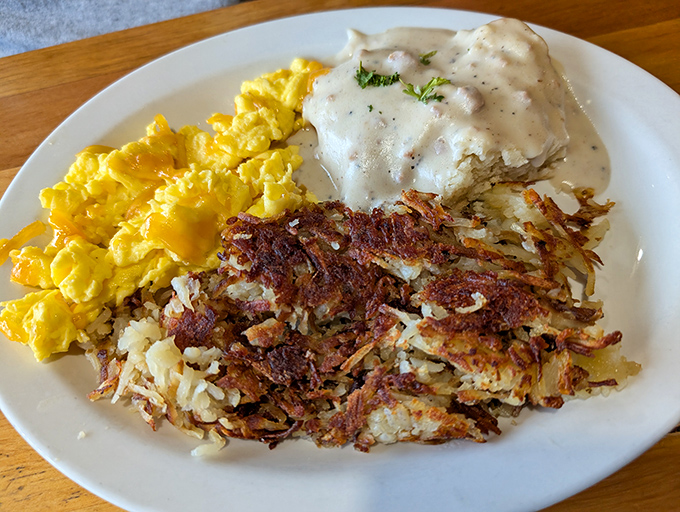 Breakfast perfection on a plate: golden scrambled eggs, crispy hashbrowns with that ideal crunch-to-tender ratio, and country gravy that means business.