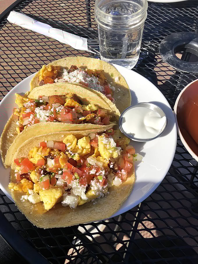 Three golden parcels of morning joy, each taco stuffed with scrambled perfection and fresh toppings.