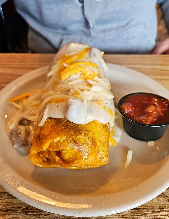 Behold the breakfast burrito in all its cheese-crowned glory! That side of salsa isn't just a condiment&mdash;it's a flavor wingman waiting to elevate each bite.