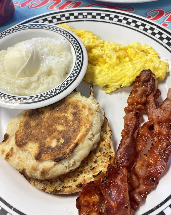 Breakfast perfection on a plate: golden biscuits, scrambled eggs that defy gravity, and bacon that should have its own fan club.