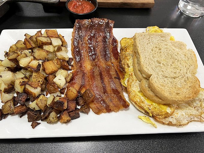 Breakfast nirvana achieved: perfectly crisped potatoes, bacon that stands at attention, and eggs that clearly graduated with honors from Breakfast Academy.