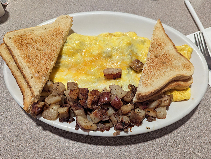 Behold the perfect omelet&mdash;golden, fluffy, and generous&mdash;flanked by home fries that could make a potato farmer weep with pride and toast that actually tastes like bread.