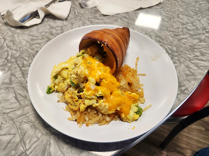 Breakfast innovation that doesn't need a hashtag&mdash;eggs and hash browns cradled in a crispy croissant cone. The morning meal reimagined without pretension.