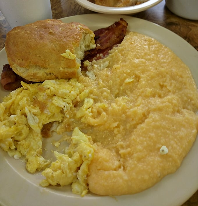 Grits so creamy they could make a Frenchman weep, eggs that practically glow, and a biscuit that deserves its own fan club.
