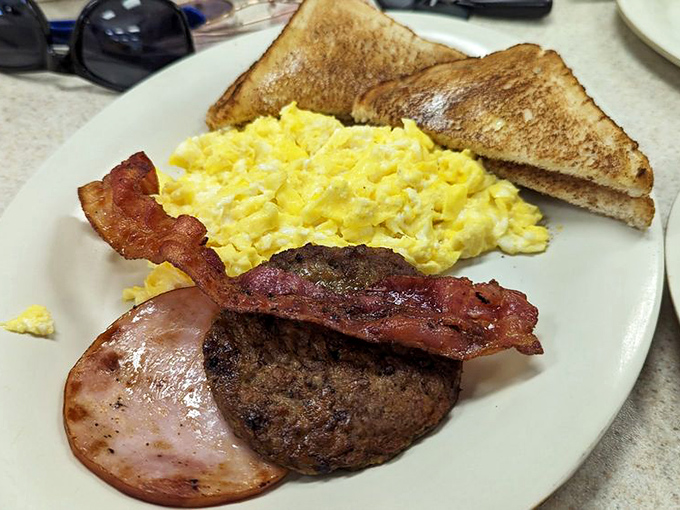 The classic breakfast trinity—eggs, bacon, and toast—executed with the kind of precision that makes you wonder if they've been studying your breakfast dreams.
