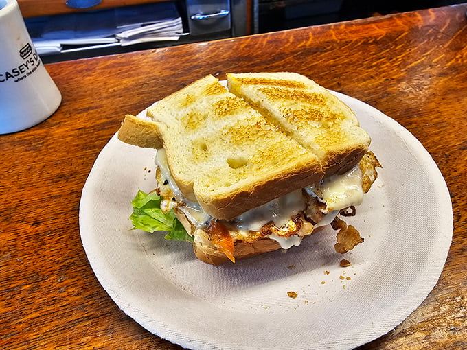 Sandwich architecture at its finest! Melty cheese cascades over perfectly fried eggs between golden toast&mdash;a breakfast masterpiece.