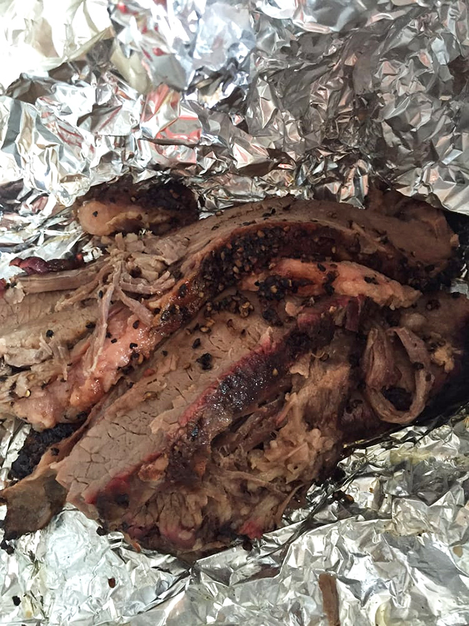 Behold the holy grail of barbecue &ndash; brisket with that perfect pink smoke ring. This isn't just meat; it's a time-honored tradition wrapped in aluminum foil.