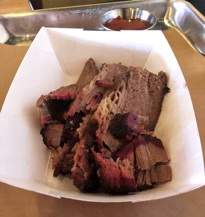Behold the star of the show: brisket with that coveted pink smoke ring and bark so perfect it deserves its own Instagram account.