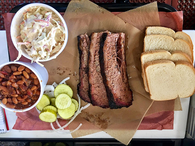 Behold the holy trinity of barbecue perfection &ndash; brisket with that telltale smoke ring, beans that didn't come from any can, and slaw for that essential crunch.