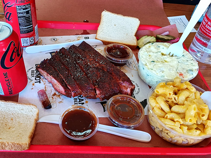 Behold the holy trinity of barbecue perfection: smoke-ringed brisket with serious bark, creamy mac and cheese, and white bread for sopping up the magic.