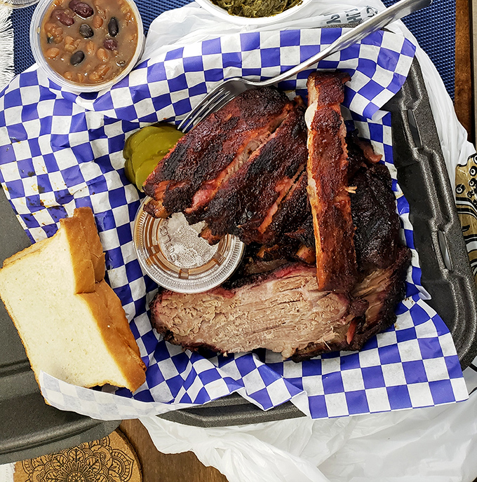 Brisket so tender it practically surrenders to your fork, with a smoke ring that would make Texas pitmasters nod in reluctant approval.