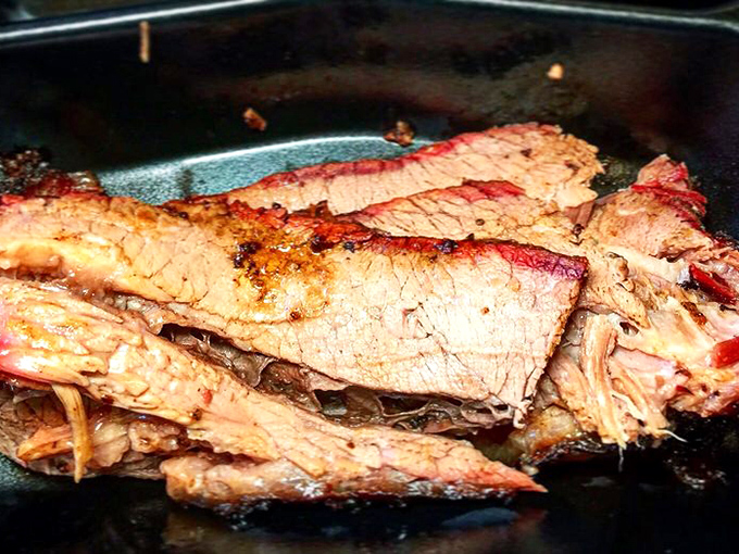 Behold the brisket in all its glory &ndash; that pink smoke ring isn't just for show, it's a badge of honor earned through hours of patient smoking.
